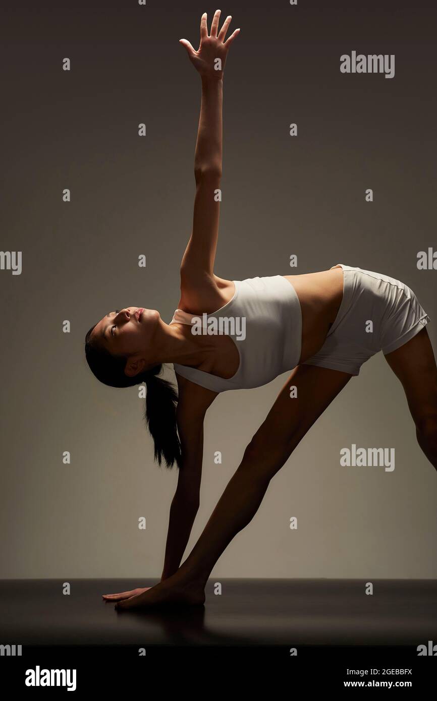 Japanese woman practicing yoga Stock Photo - Alamy