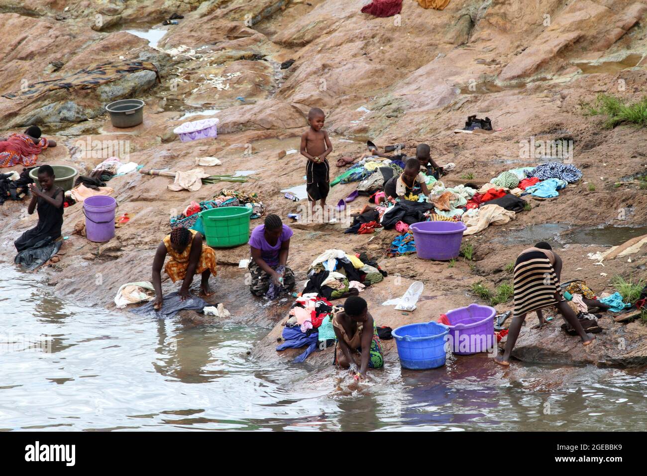 Women are seen washing their clothes in Lilongwe river as the children ...