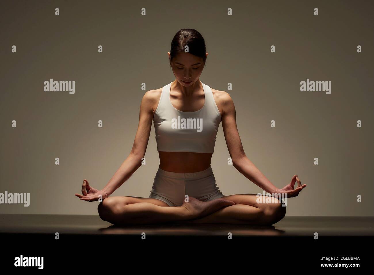 Japanese woman practicing yoga Stock Photo - Alamy