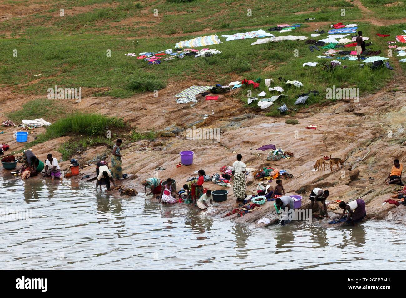 Women are seen washing their clothes in Lilongwe river as the children ...