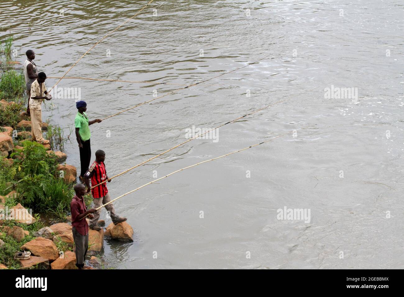 Five men are seen fishing in Lilongwe river using makeshift fishing ...