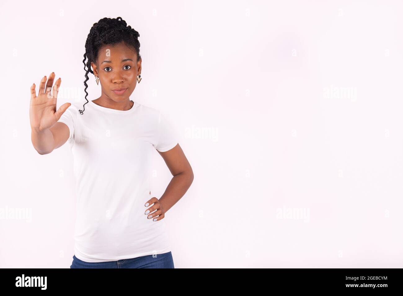Afro american woman with a stern face holding her hand at the camera ...