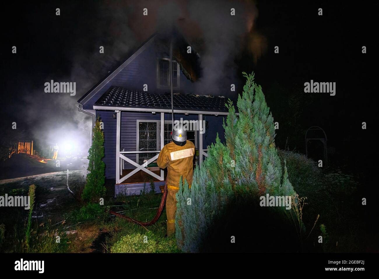 Firemen extinguish fire in rural house at night Stock Photo - Alamy