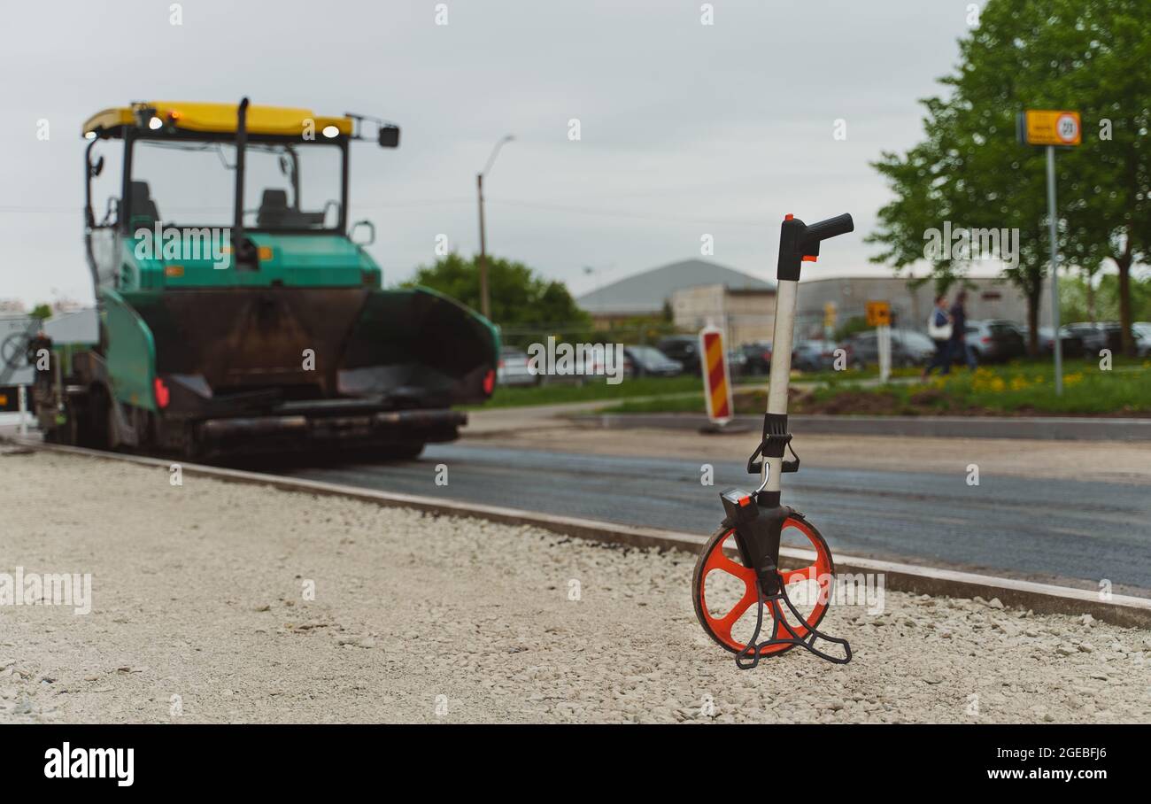 Measuring wheel tool on the road reconstruction site Stock Photo - Alamy