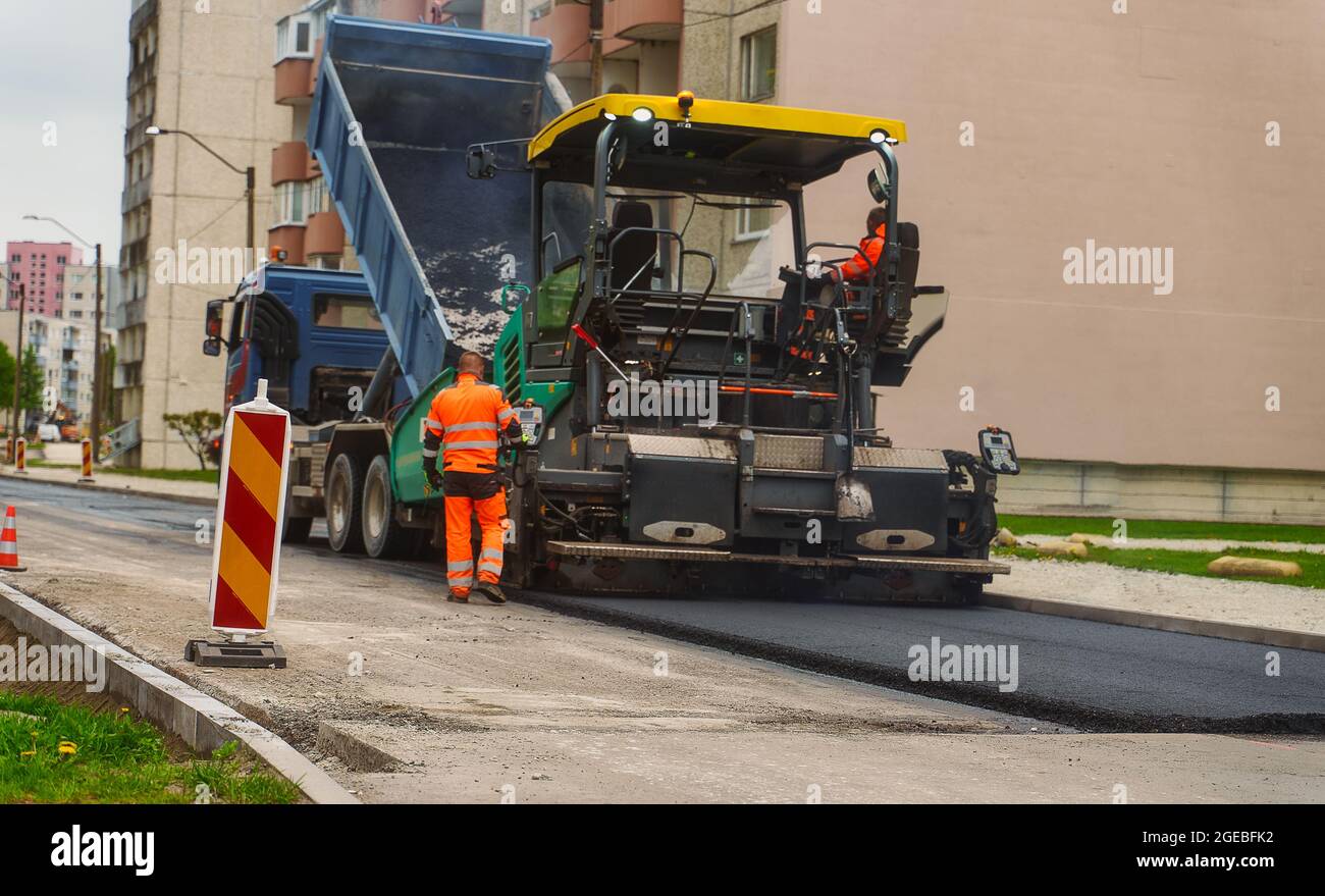 Road paving machine stacking asphalt on the street Stock Photo - Alamy