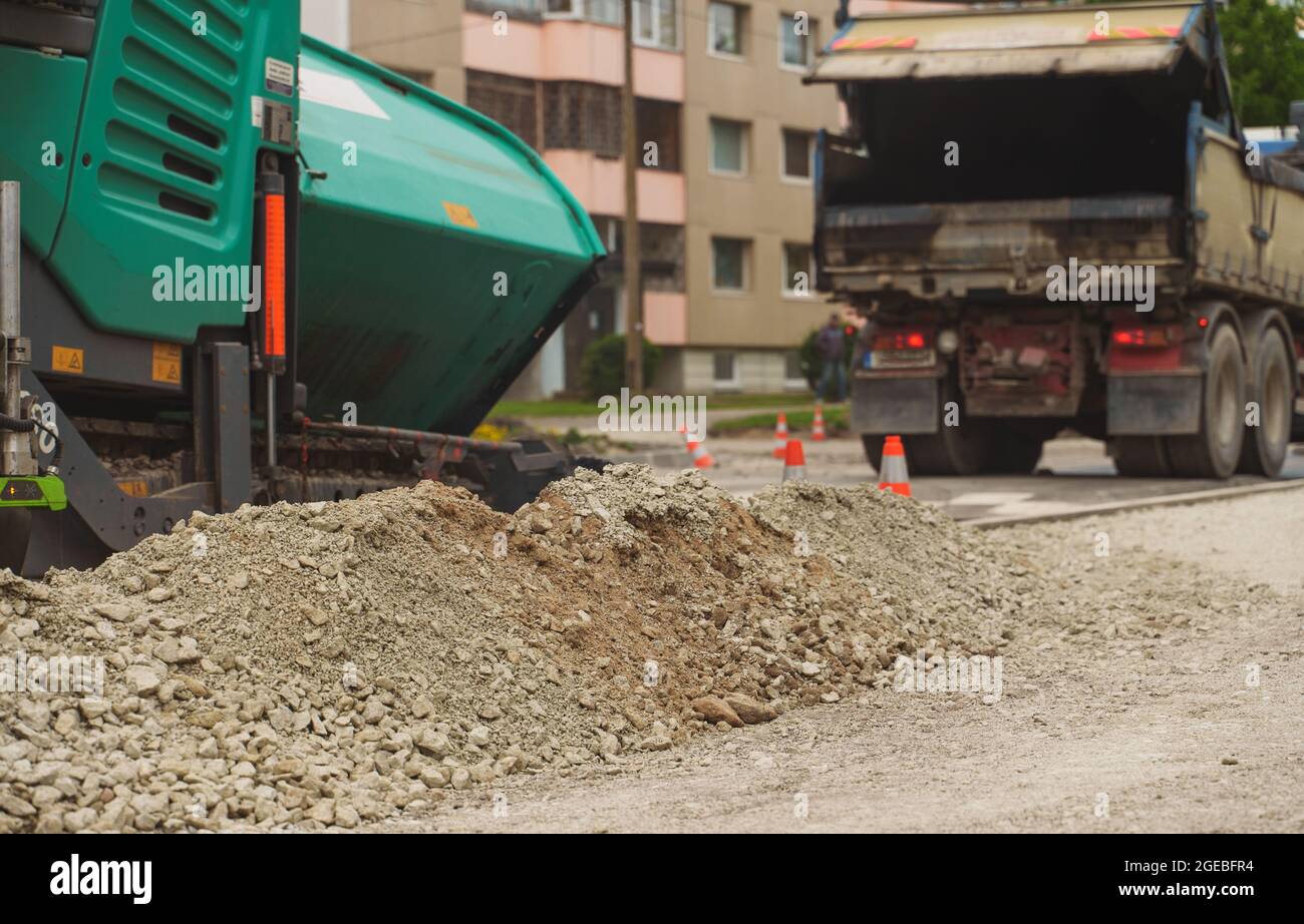 Road paving machine stacking asphalt on the street Stock Photo - Alamy