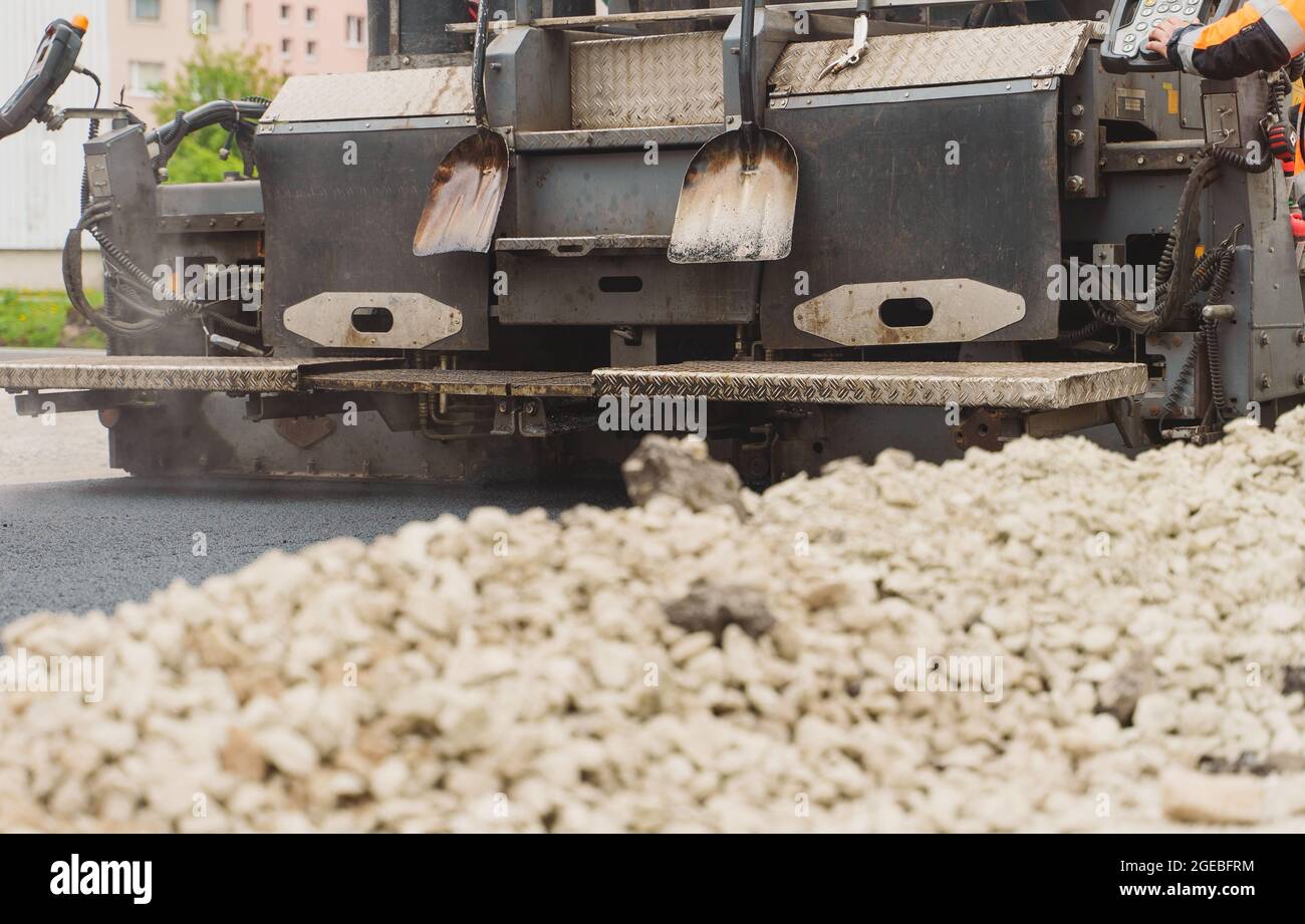 Road paving machine stacking asphalt on the street Stock Photo - Alamy