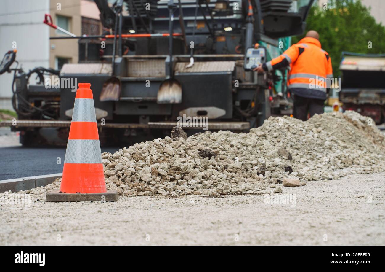 Road paving machine stacking asphalt on the street Stock Photo - Alamy