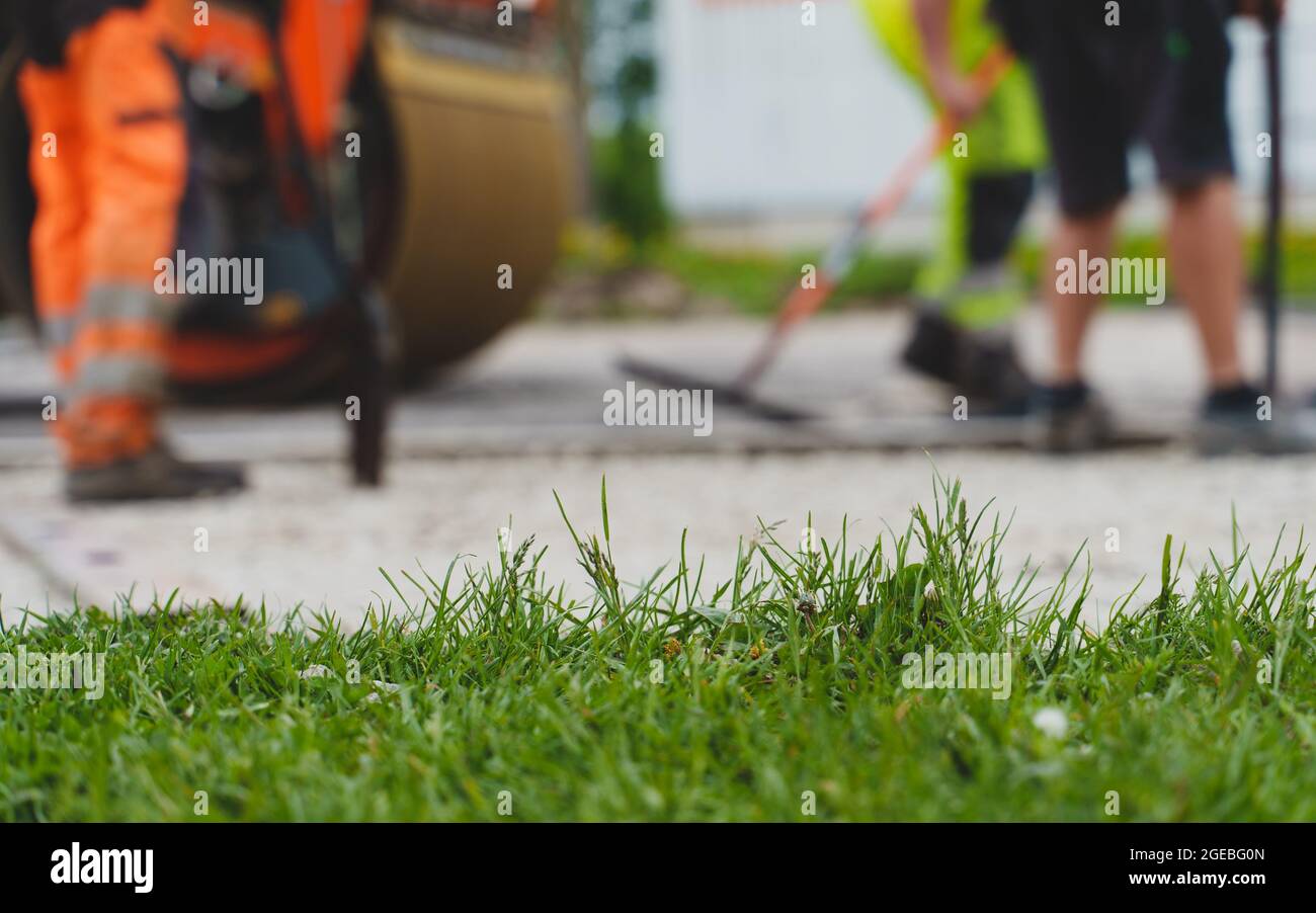Road reconstruction. Heavy vibration road roller stacking hot asphalt ...