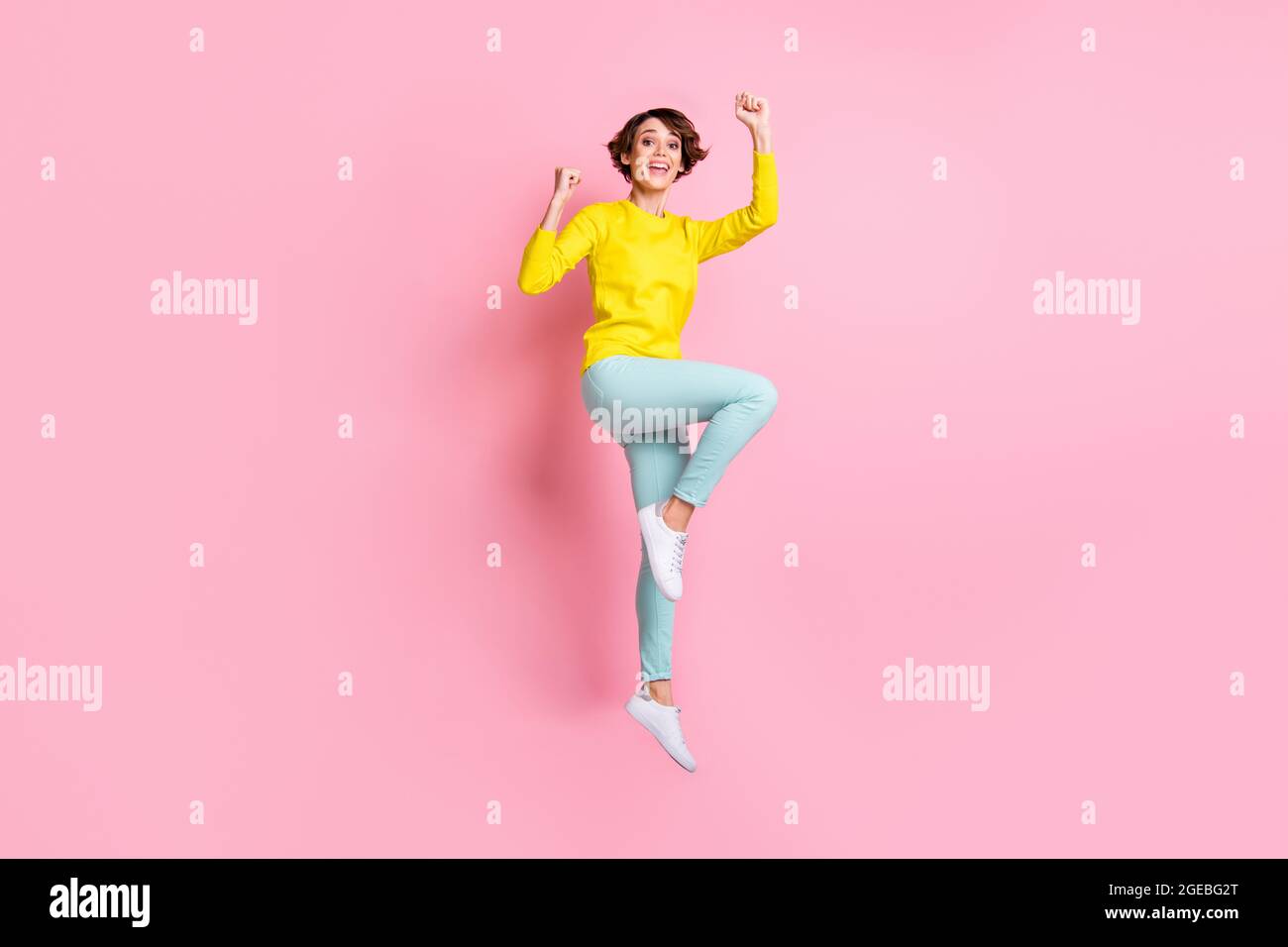 Full length body size photo of model jumping high gesturing like winner ...