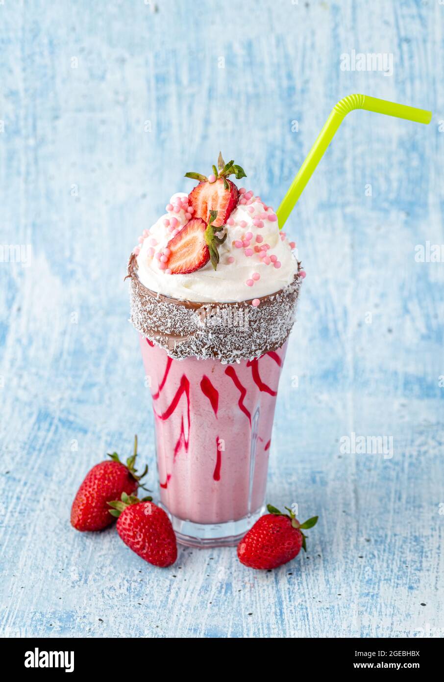 Refreshing strawberry milkshake on blue stone background Stock Photo ...