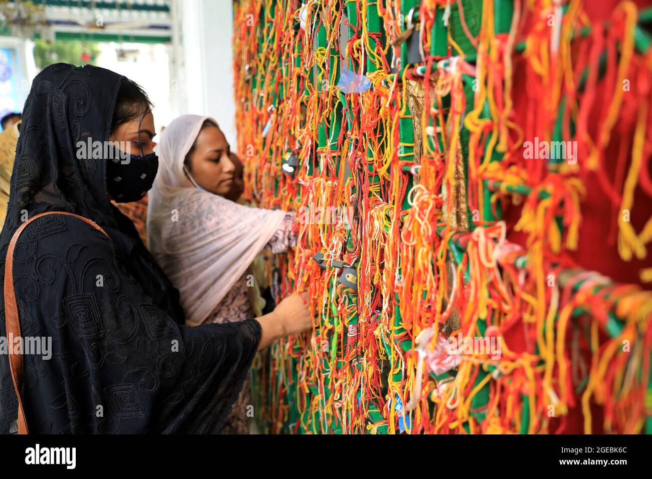 Dhaka, Bangladesh, August 18, 2021: Muslim women tie the Tajia as ...
