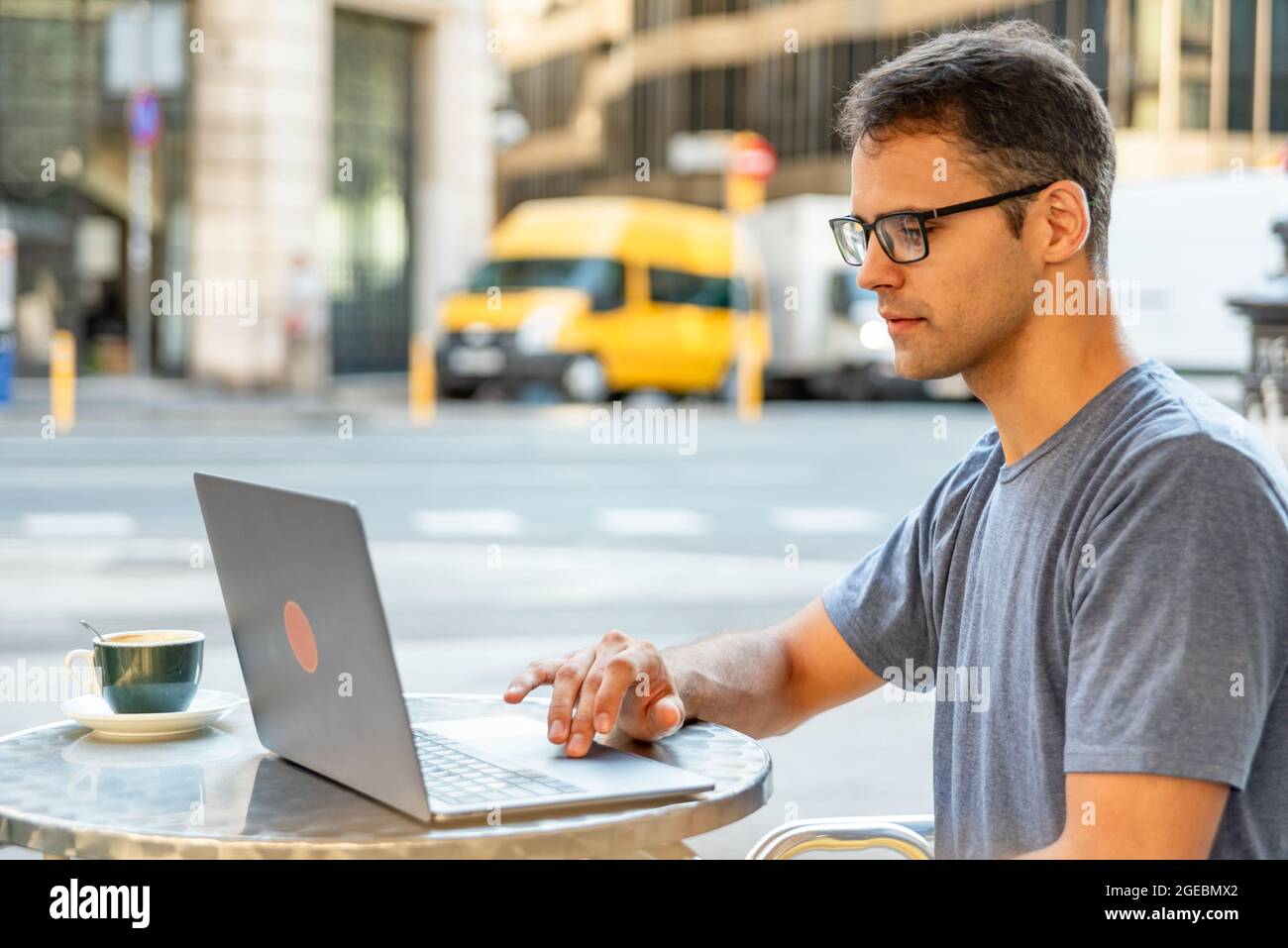 Young latin man enjoying working with computer outside Stock Photo - Alamy