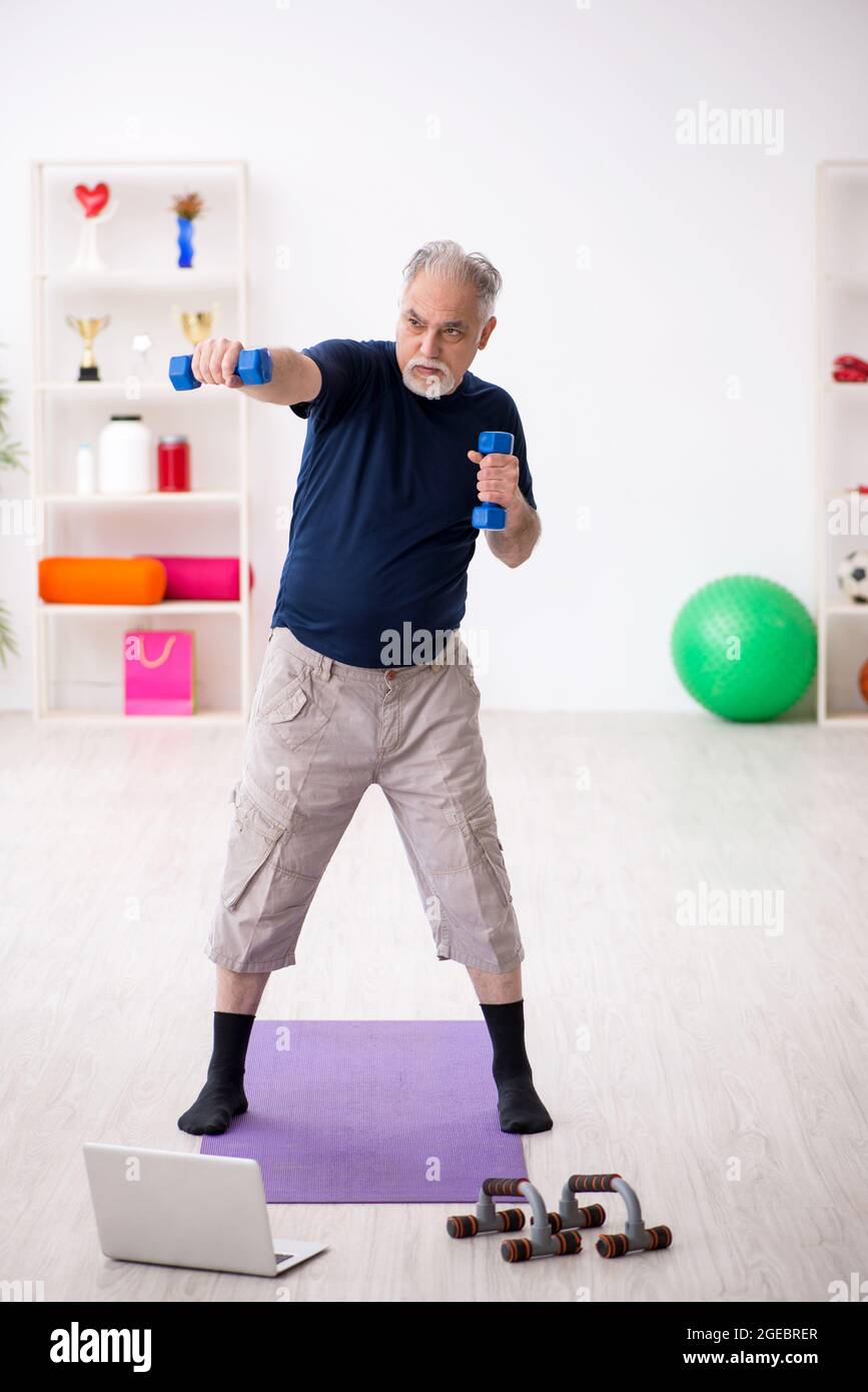 Old man doing sport exercises at home Stock Photo - Alamy