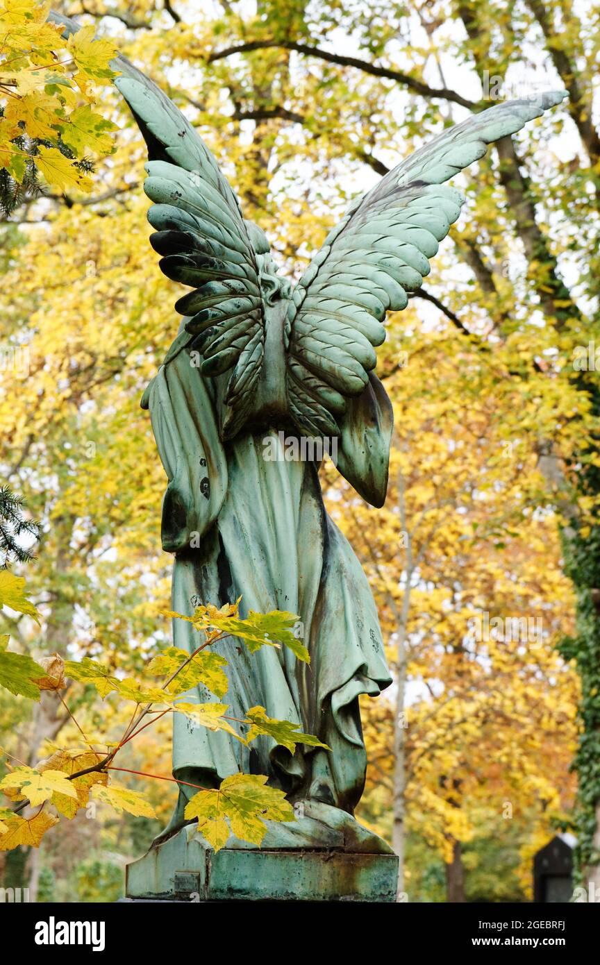 an angel figure in an autumnal cemetery Stock Photo - Alamy