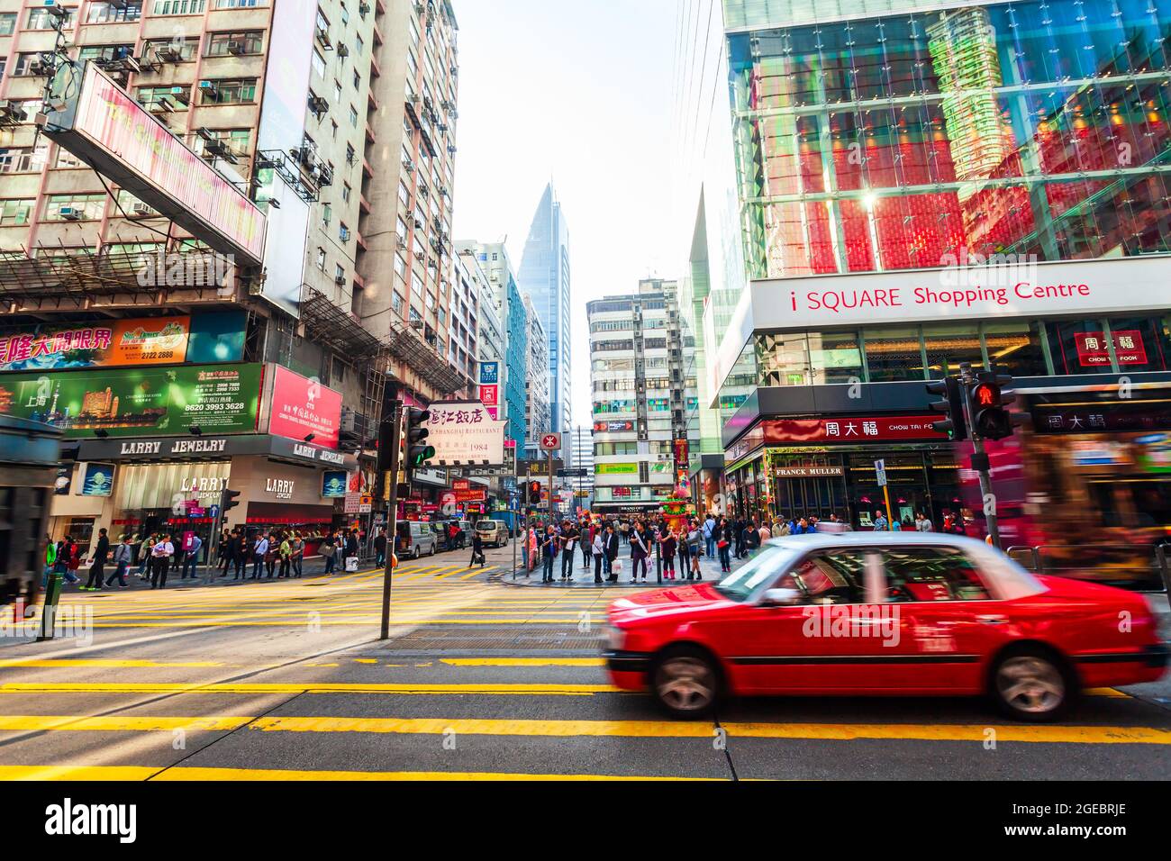 HONG KONG - FEBRUARY 21, 2013: Red taxi on a busy street. Red taxi is a ...