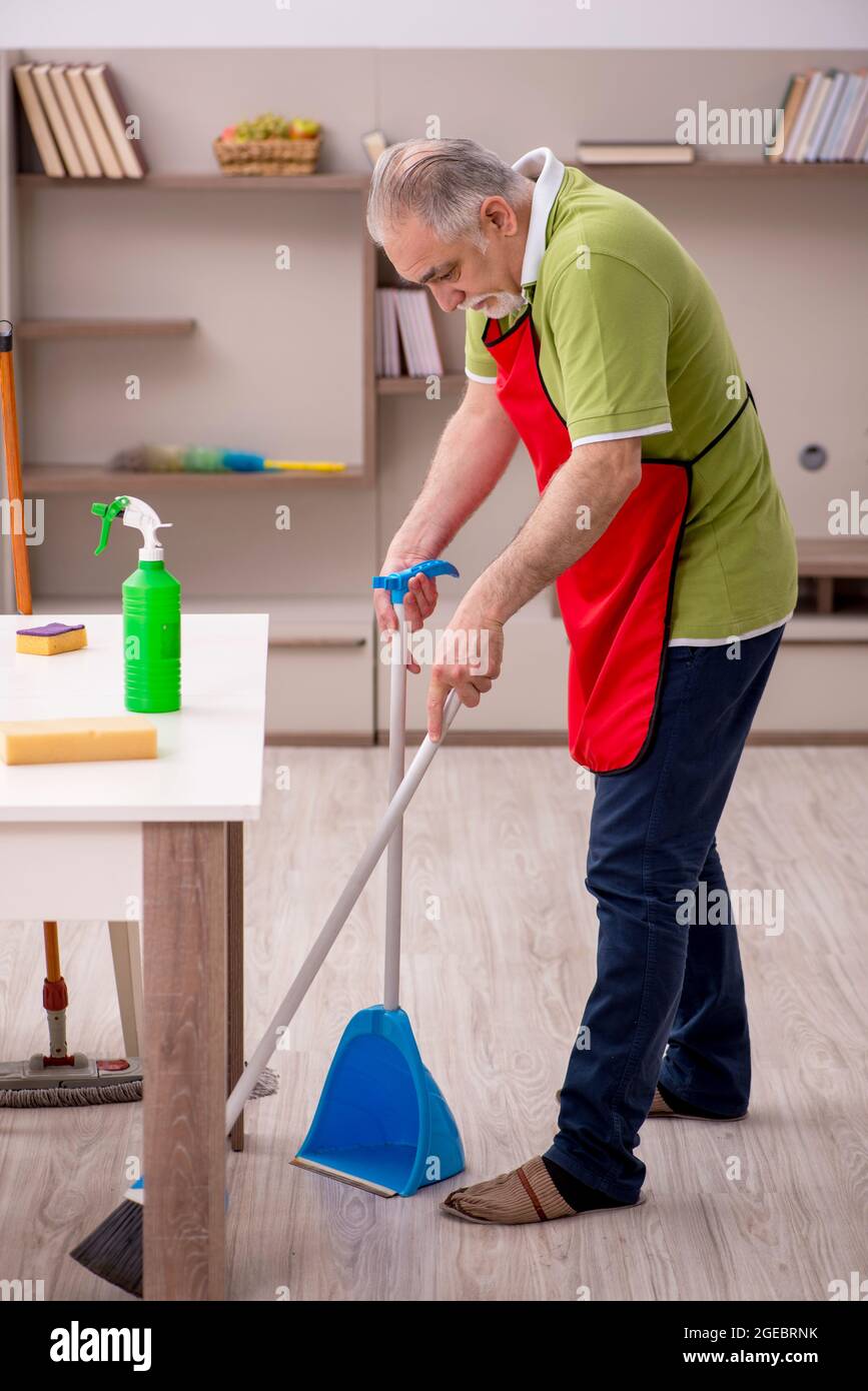 Aged man cleaning the house Stock Photo - Alamy