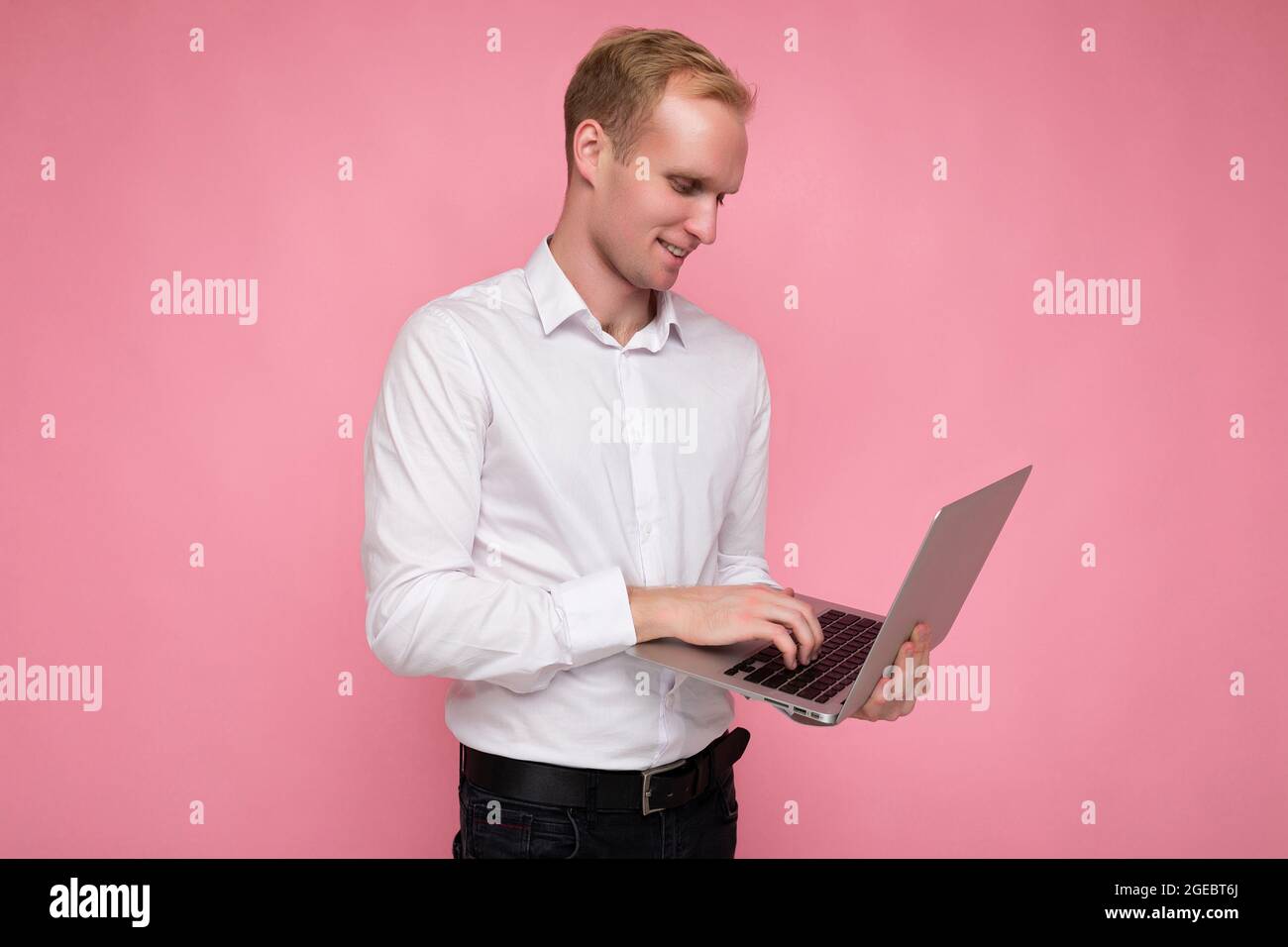 Side profile photo shot of handsome confident blonde young man holding ...