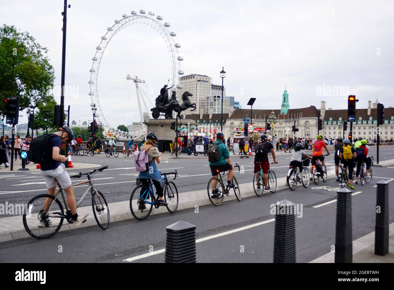 Line of cyclists on Westminster Bridge, London, United Kingdom Stock ...