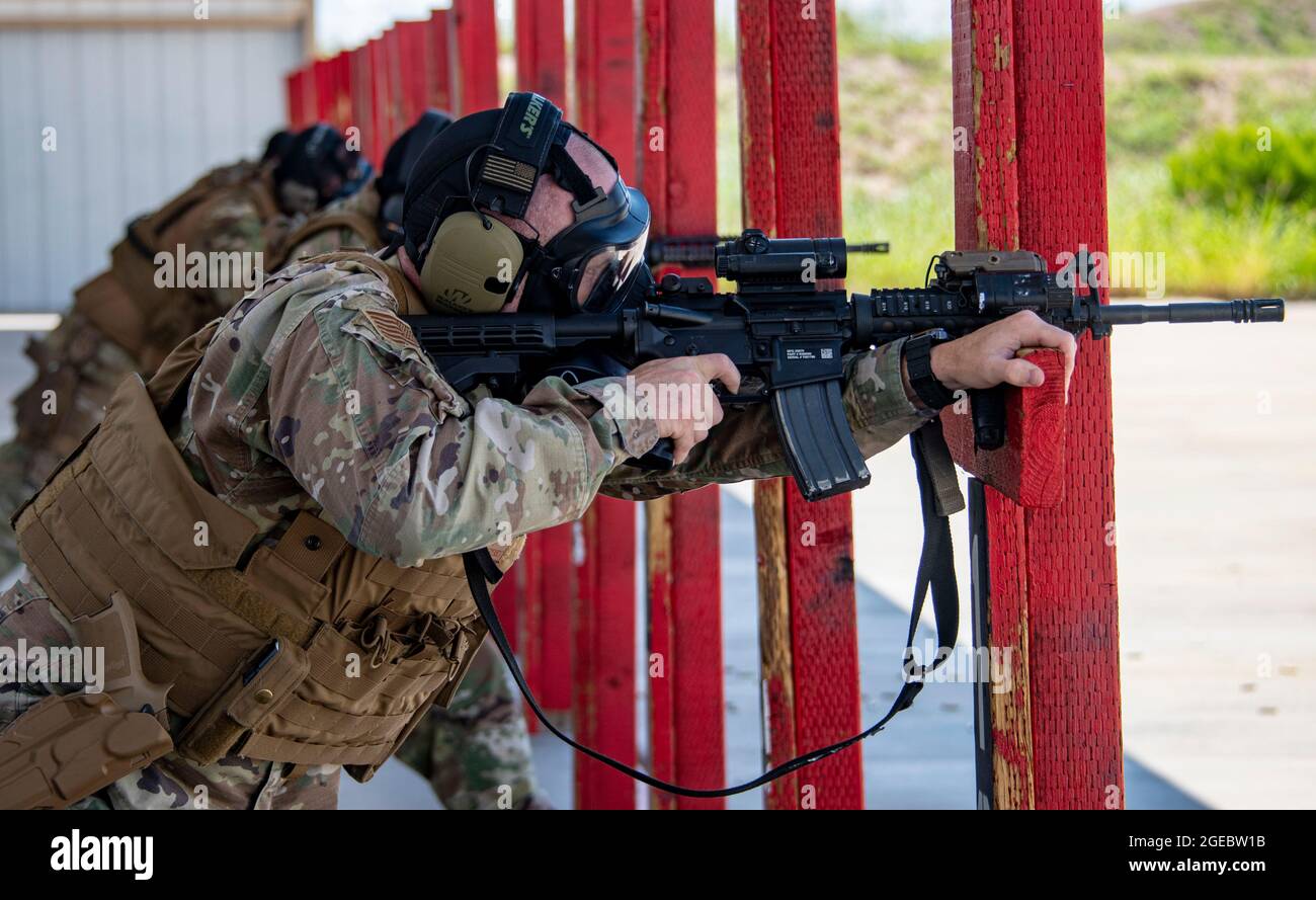 An Airman assigned to the 355th Security Forces Squadron fires an M4 ...