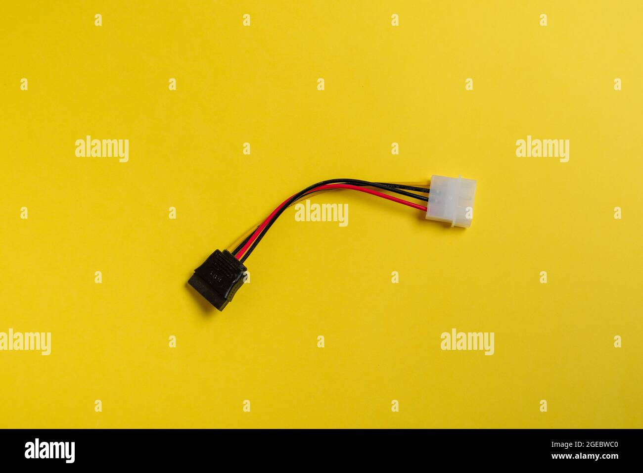 computer cord on a yellow background Stock Photo - Alamy