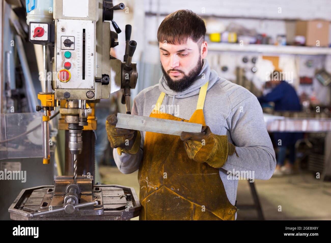 Craftsman working on metal structures drilling machine Stock Photo - Alamy