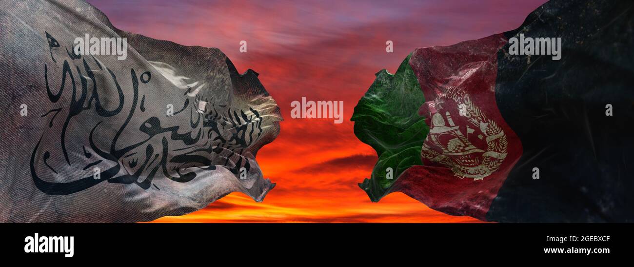 retro old flags of afghanistan and taliban waving in the wind ...