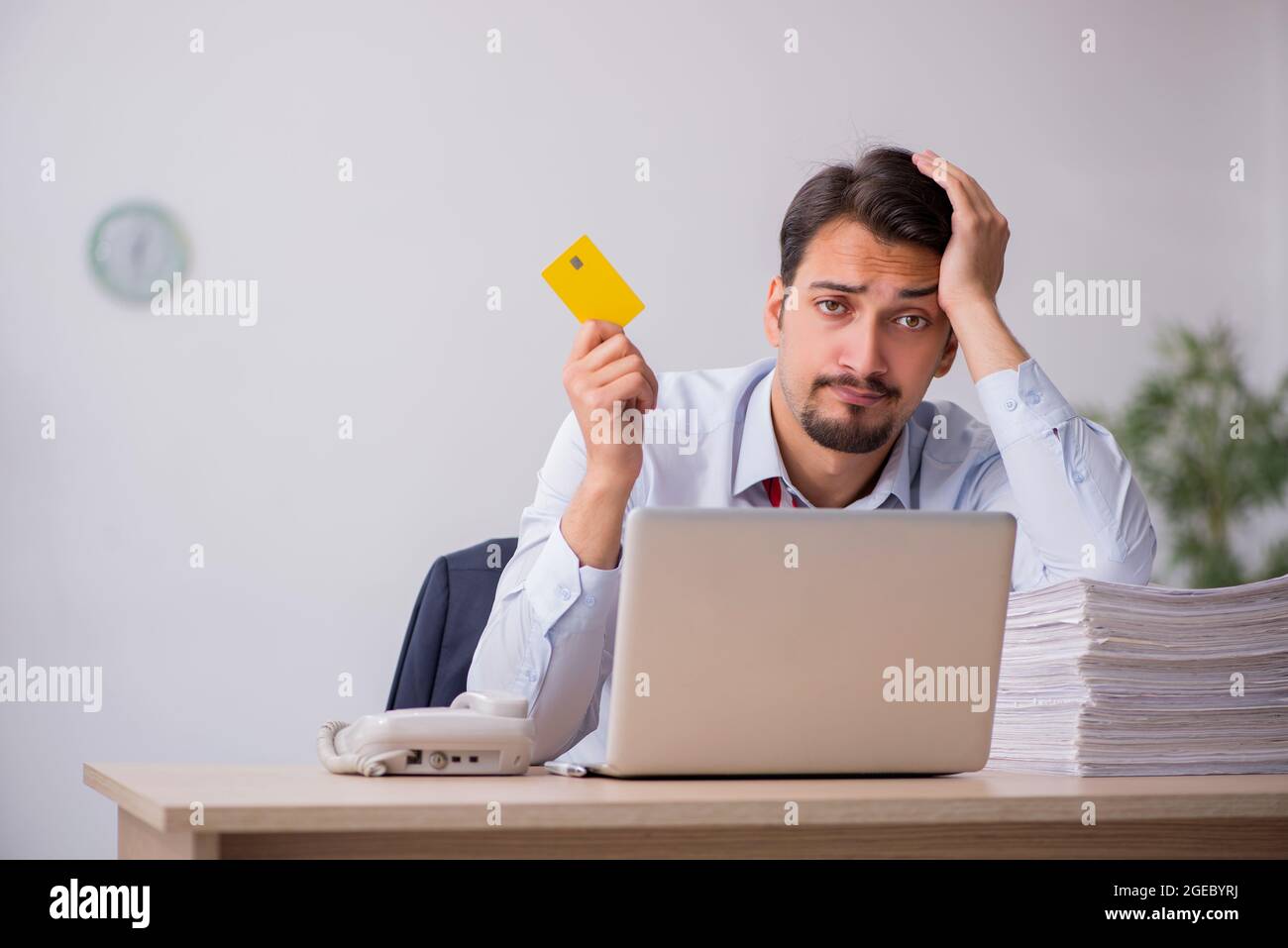 Young businessman employee holding credit card in the office Stock ...