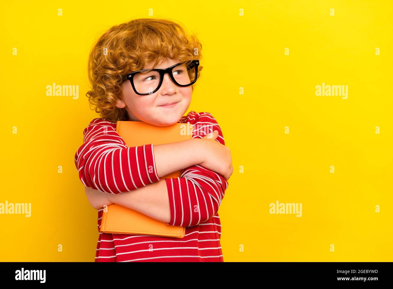 Photo of young happy dreamy charming boy look empty space smile hug ...