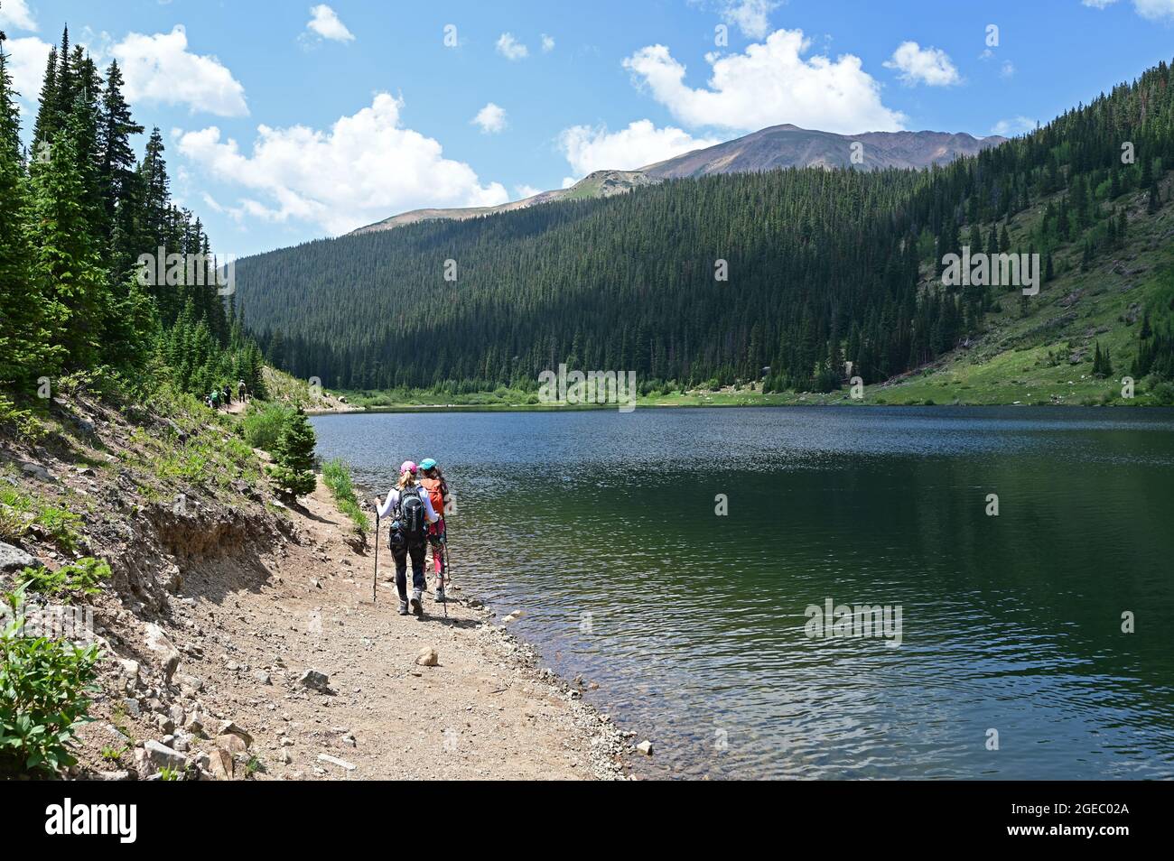 Two young female hikers on shore of Upper Urad Reservoir on Hassell ...