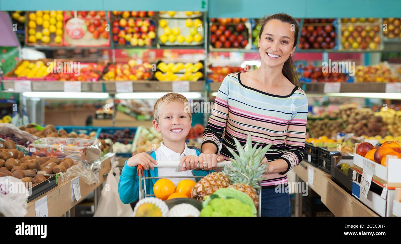 mother with little boy buying fruits and vegetables at store Stock ...