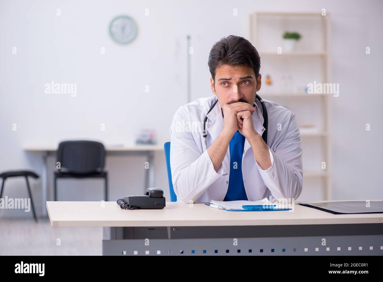 Young doctor working in the clinic Stock Photo - Alamy