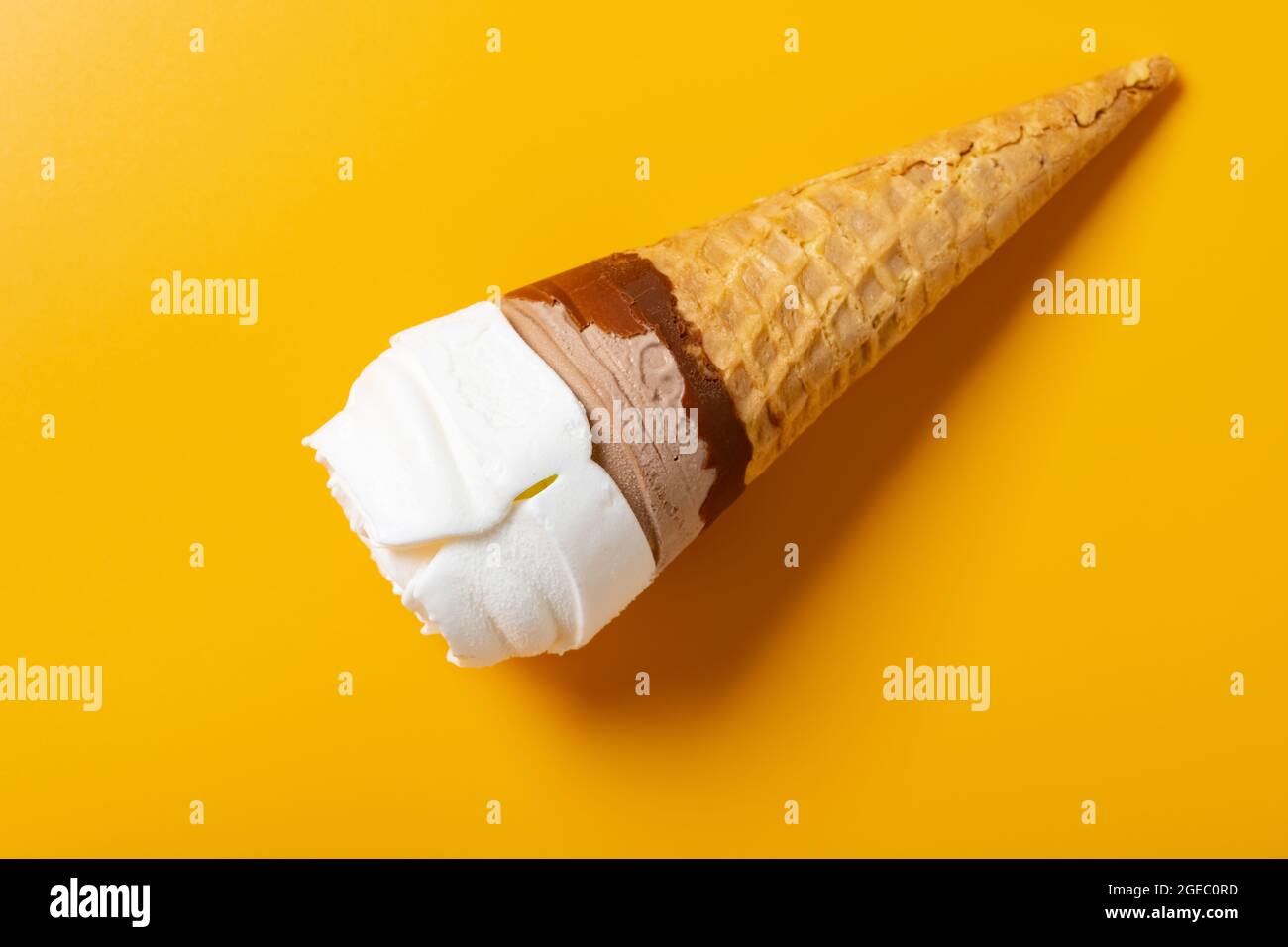 top view flower shape cocoa flavor ice cream cone on a yellow ...