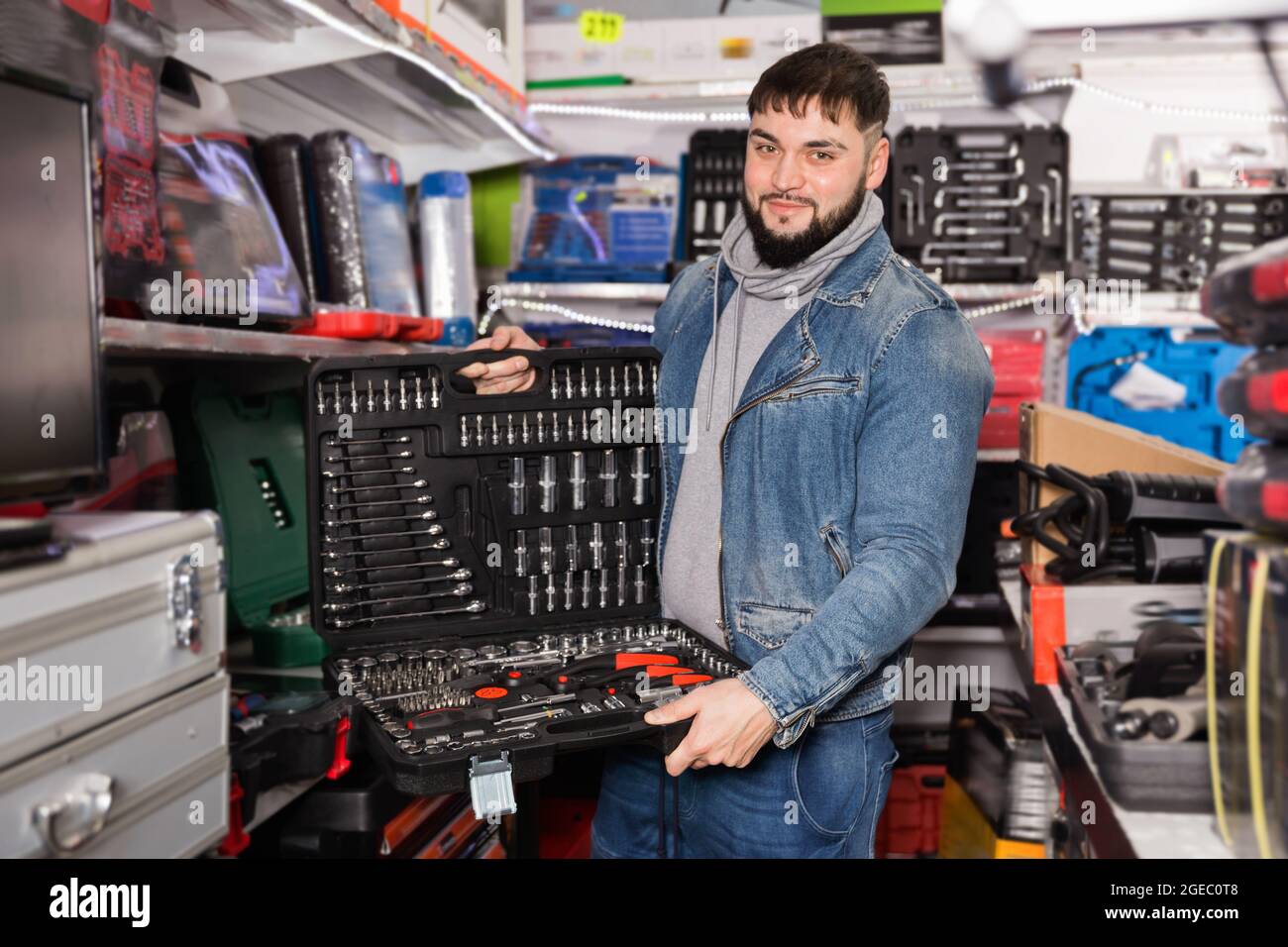 Worker chooses set of tubular keys and set of heads for work in tools ...