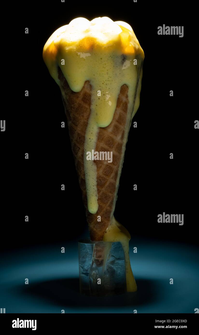 melting ice cream cone highlighted in dark Stock Photo - Alamy