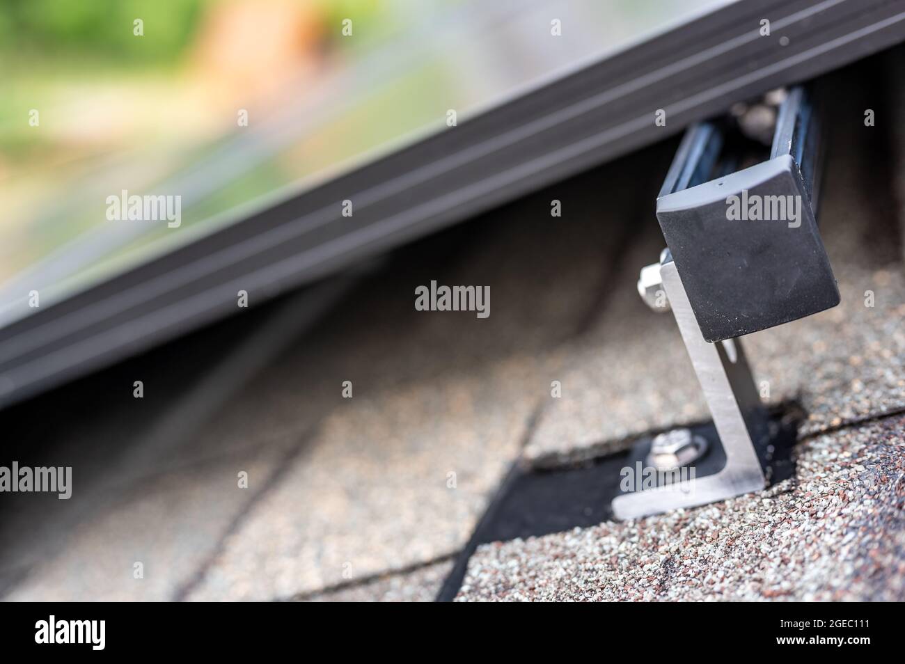 Rail, bracket, and anchor to a solar panel installed on a asphalt ...
