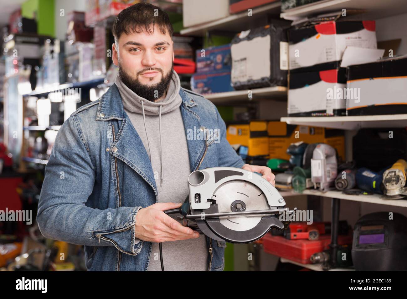 male engineer chooses circular saw in tool store Stock Photo - Alamy
