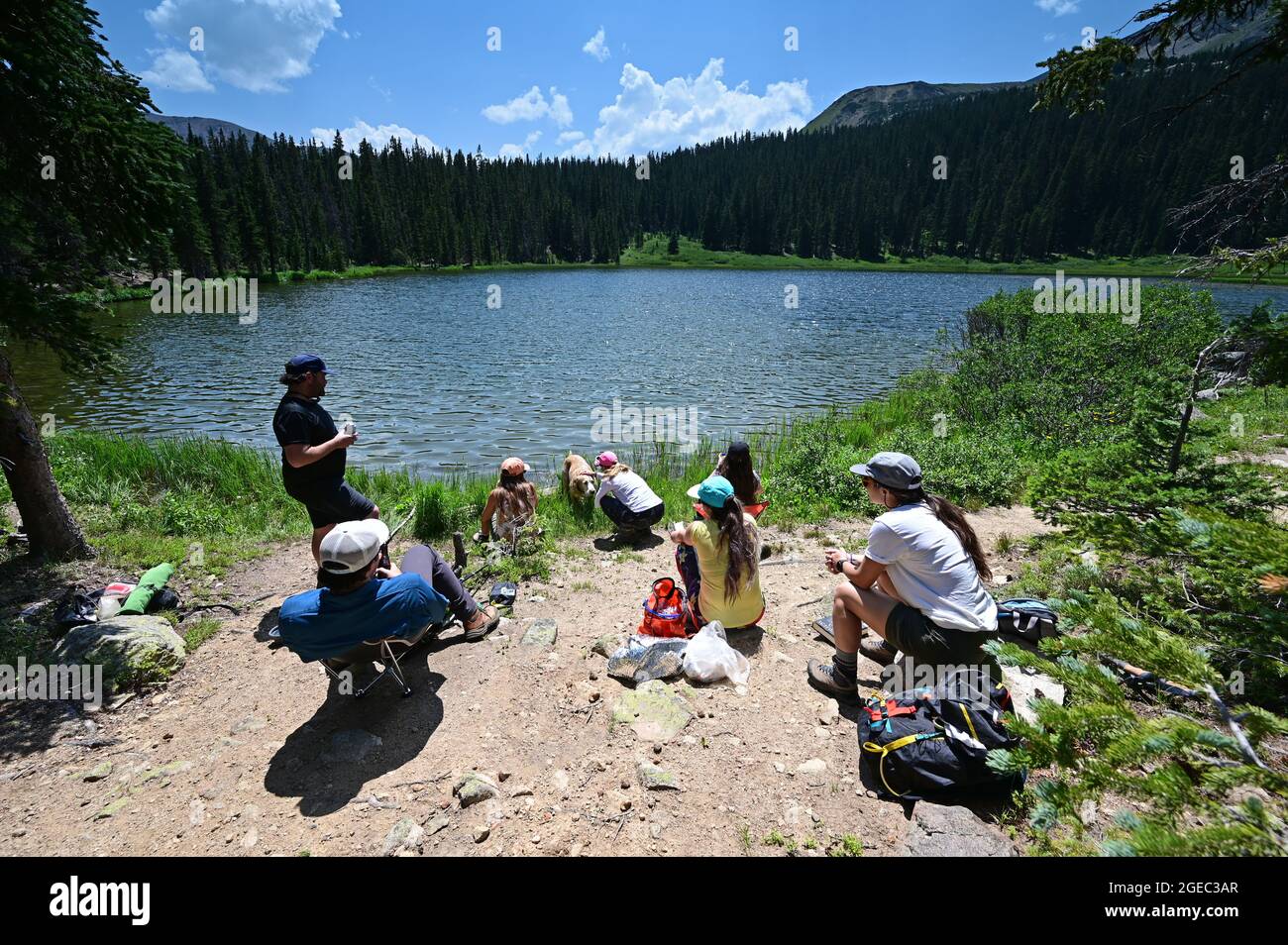 Hikers enjoy view of Hassell Lake in Arapaho National Forest, Colorado ...