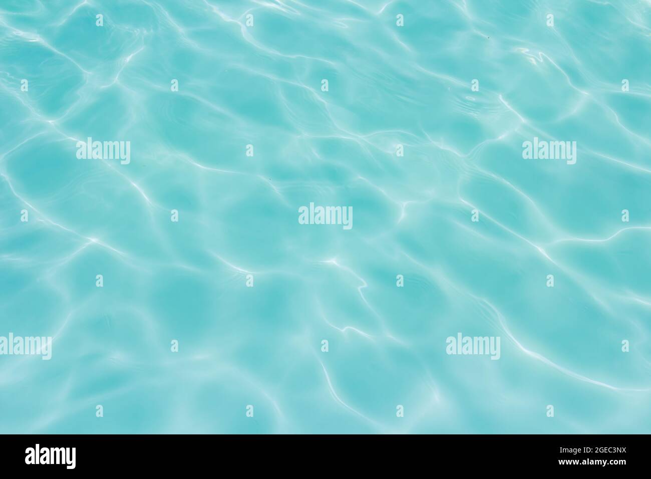 Blue swimming pool with sunny reflections background Stock Photo - Alamy