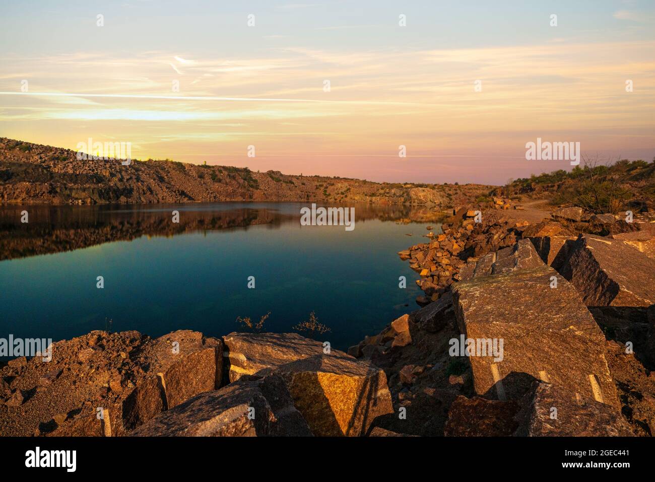 Small lake surrounded by stone waste from mine work Stock Photo - Alamy