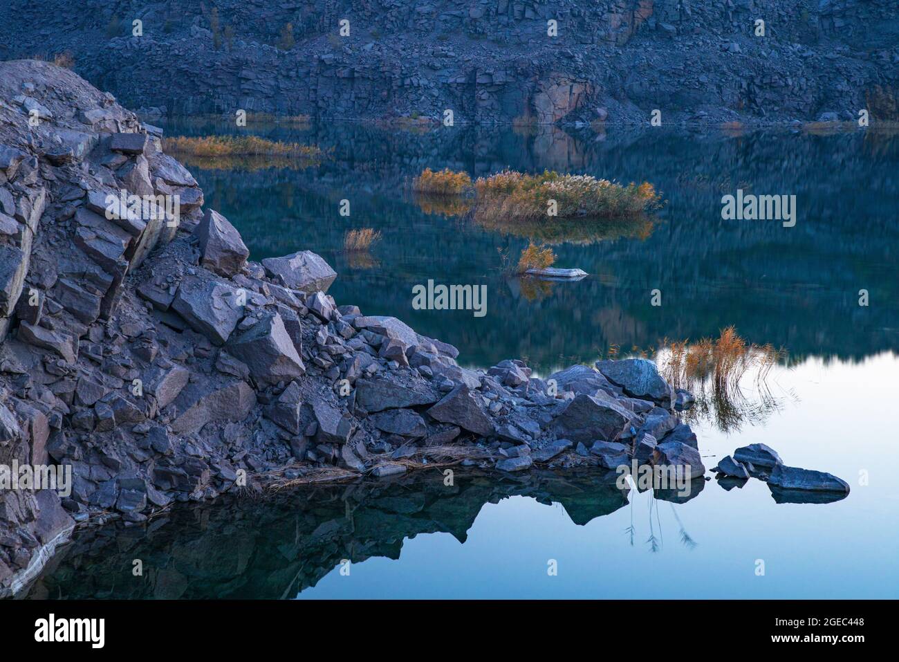 Small lake surrounded by stone waste from mine work Stock Photo - Alamy