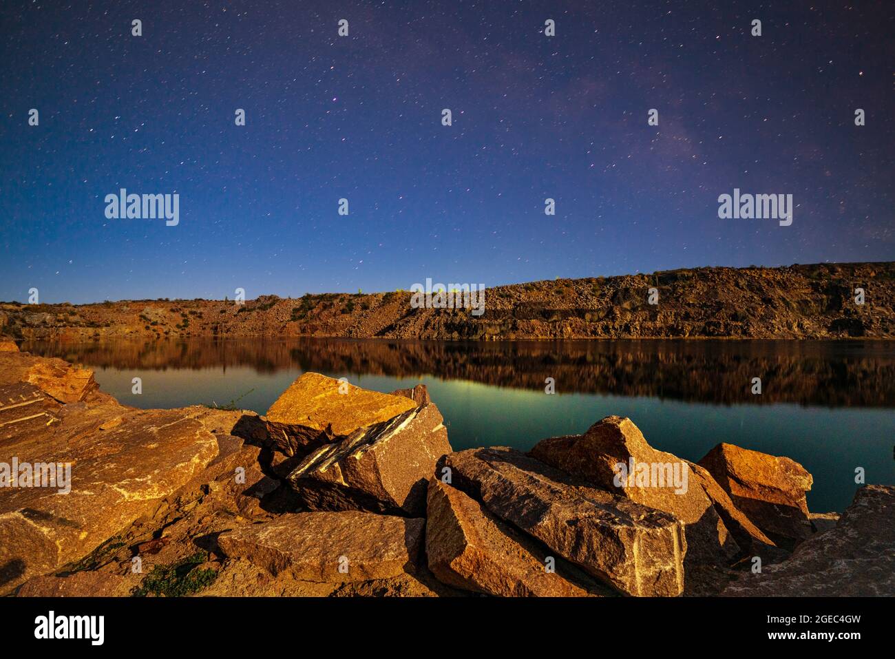 Small lake surrounded by stone waste from mine work Stock Photo - Alamy
