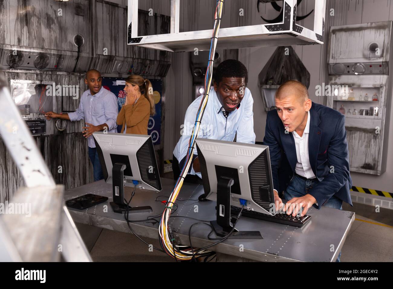 Colleagues playing in quest room during team building Stock Photo - Alamy