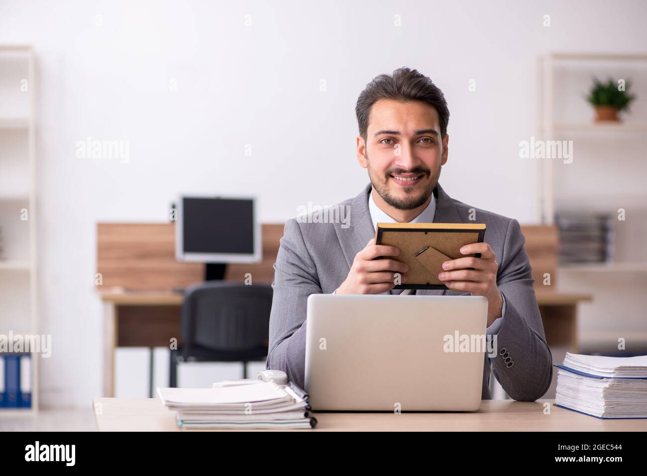 Young businessman employee missing girlfriend at workplace Stock Photo ...