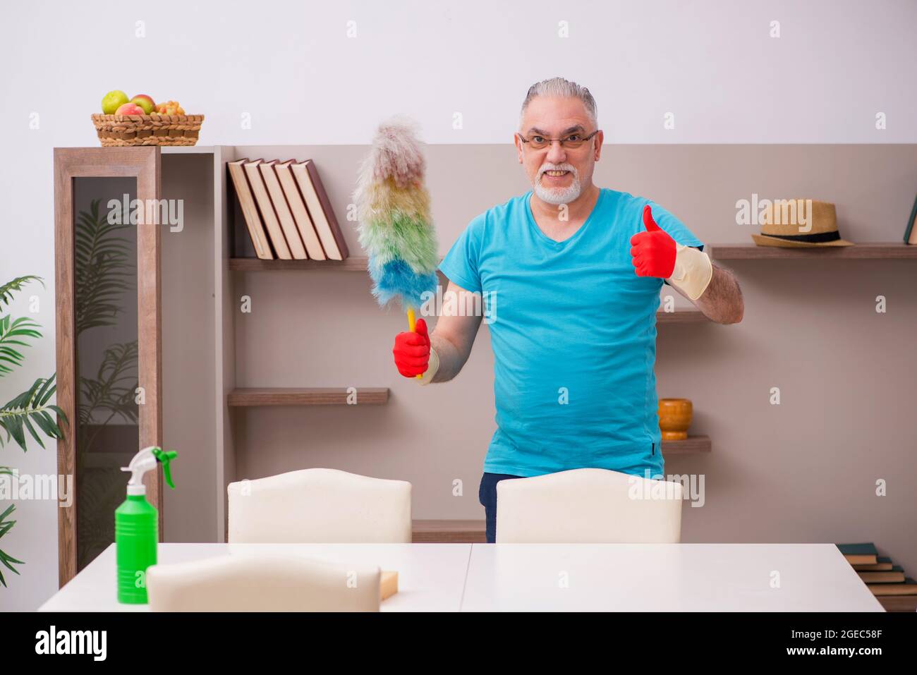 Aged man cleaning the house Stock Photo - Alamy