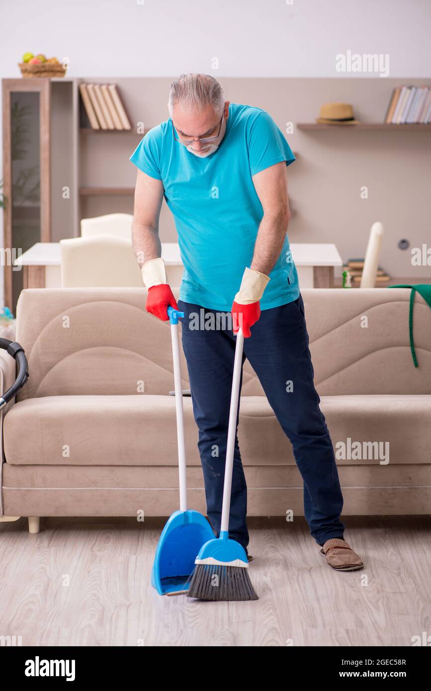 Aged man cleaning the house Stock Photo - Alamy