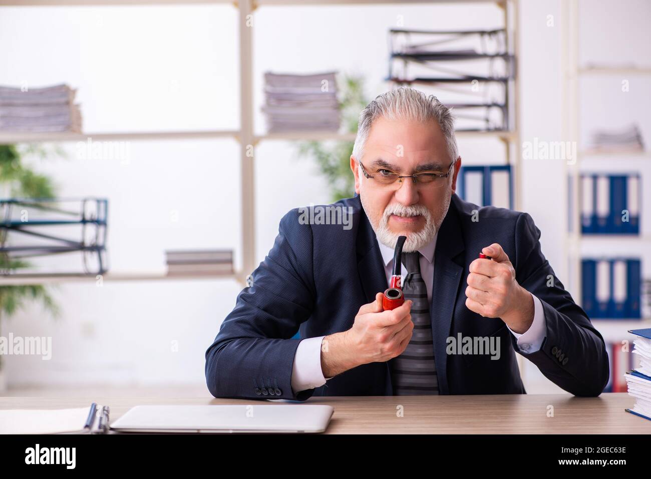 Old businessman employee smoking pipe at workplace Stock Photo - Alamy