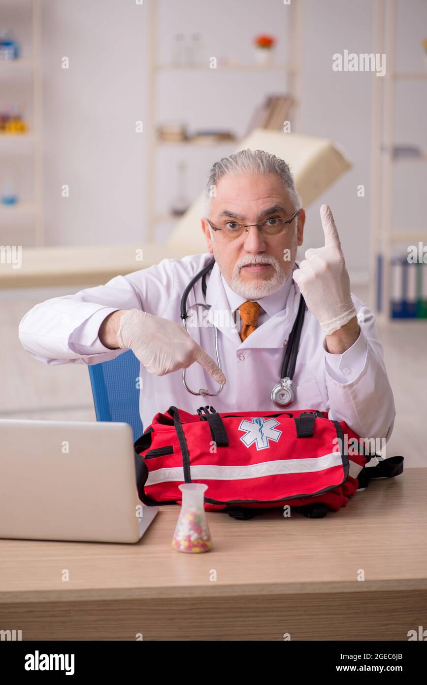 Old doctor in first aid concept Stock Photo - Alamy