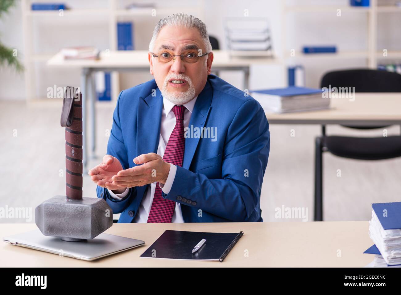 Old busynessman employee unhappy with too much work in the office Stock ...