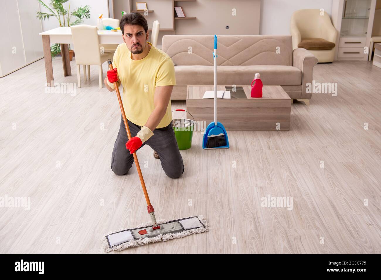 Young male cleaner cleaning the house Stock Photo - Alamy
